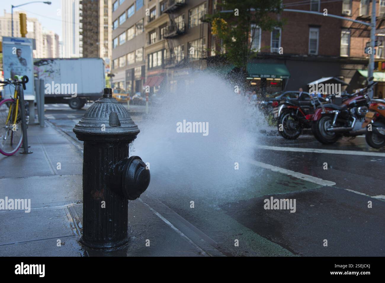 Spray of water from broken johnny pump on Manhattan, New York, USA ...