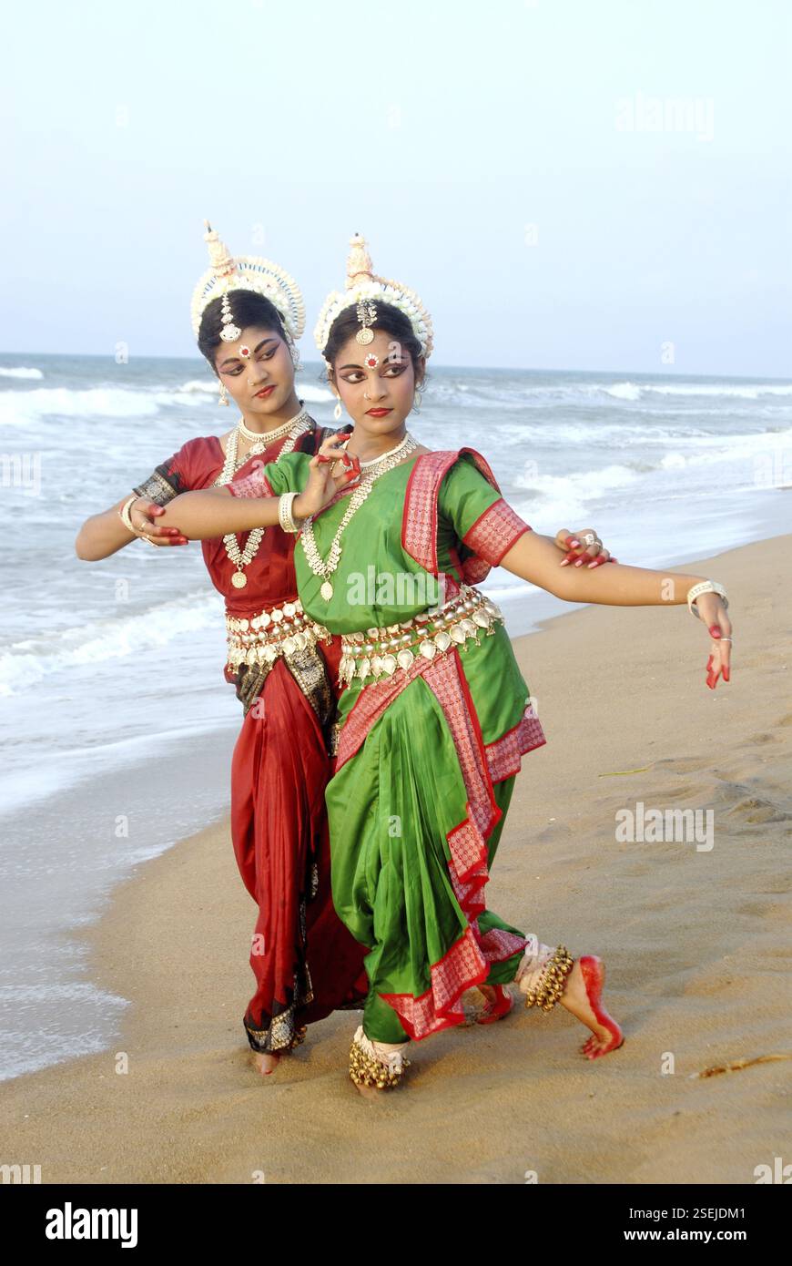 Dancers performing classical traditional odissi dance in front of bay ...