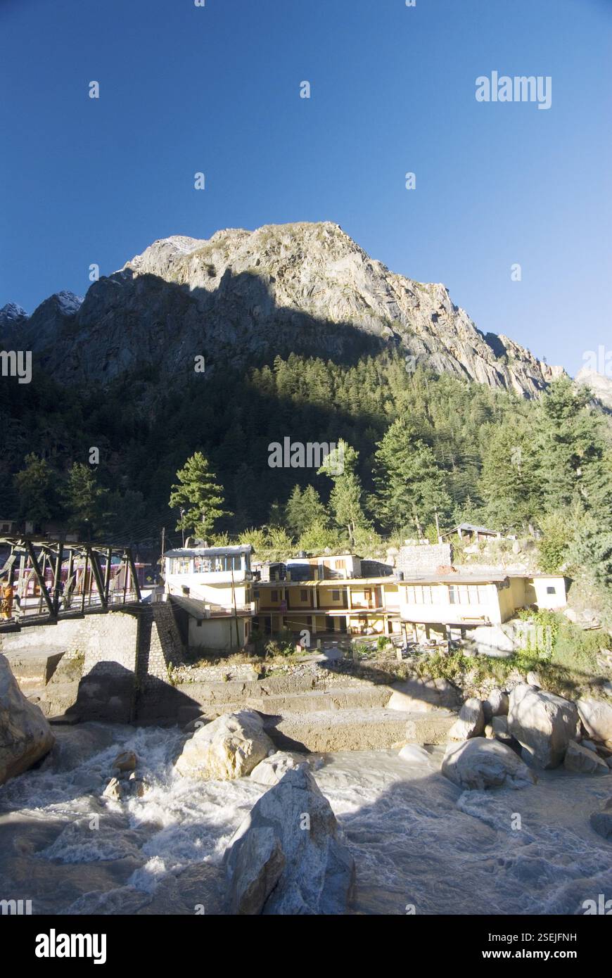 Bridge on river Ganga and Himalayan village at Gangotri in morning ...