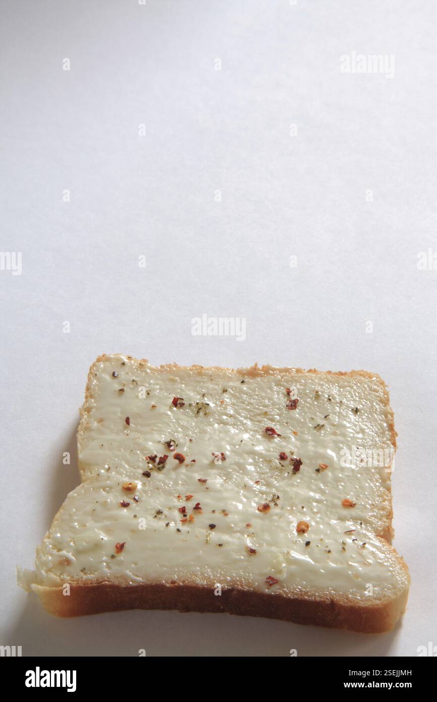 Breakfast food, bread cheese spread garnish with chilly powder on white ...
