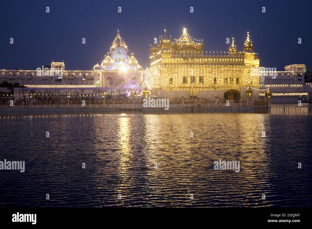 Illuminated Harimandir Sahib swarn mandir or golden temple during ...