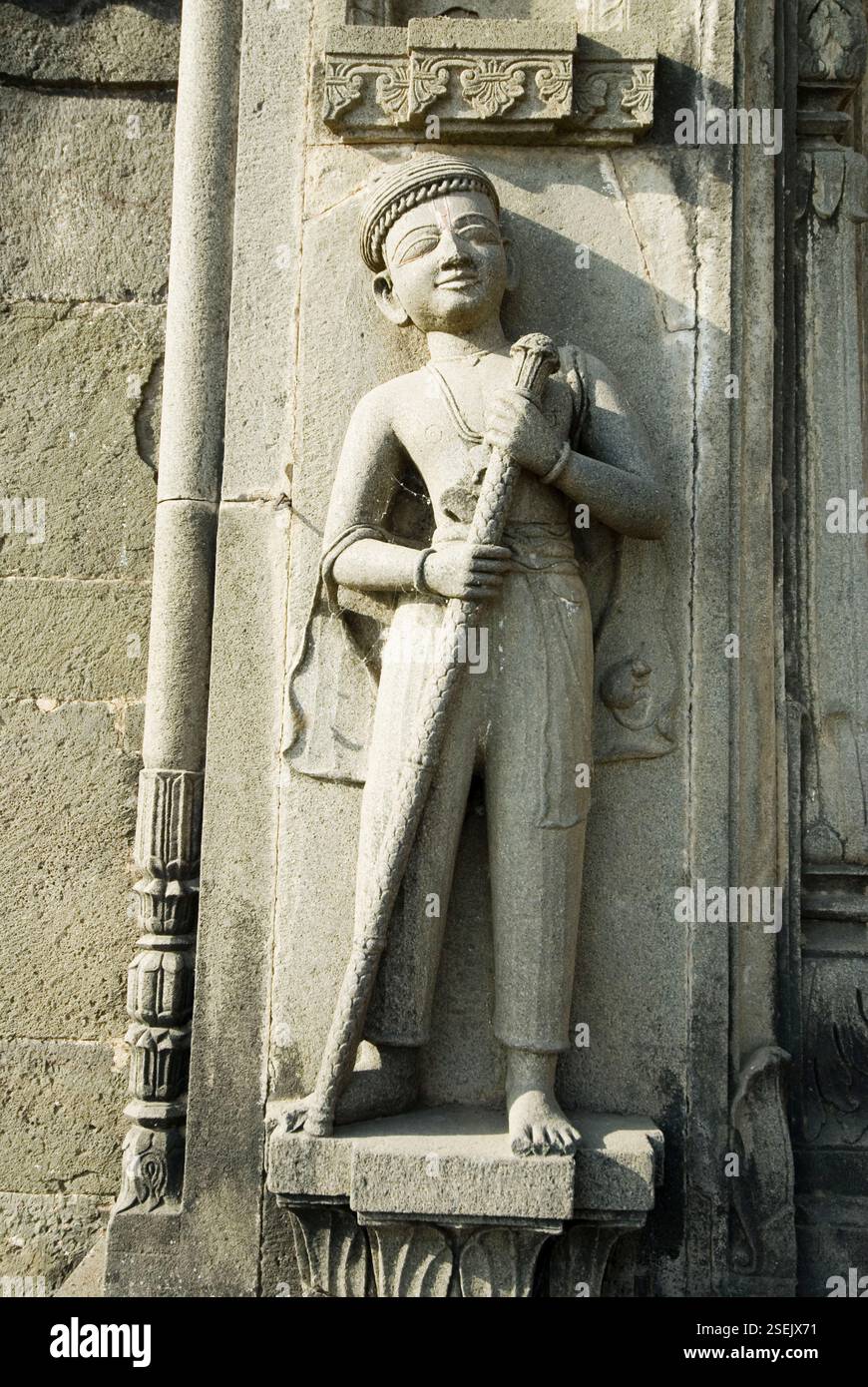 Guard watchman carved in stone on gate of Maheshwar temple, Maheshwar ...