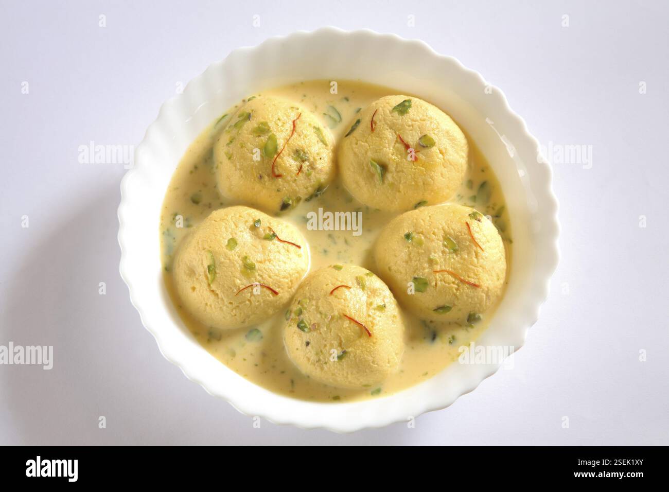 Indian sweet, kesar rasmalai garnish with pistachio and saffron served ...