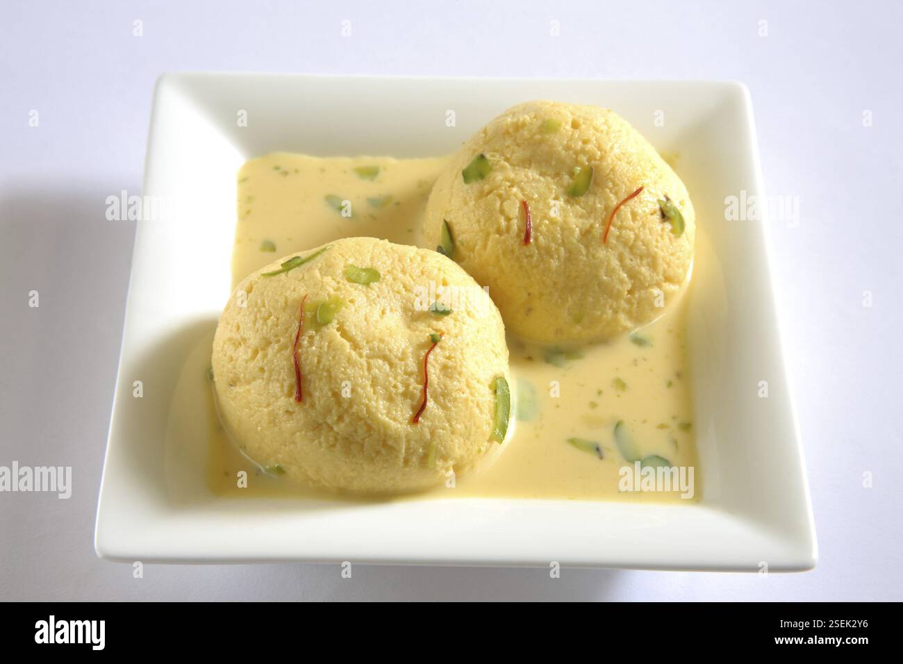 Indian sweet, kesar rasmalai garnish with pistachio and saffron served ...