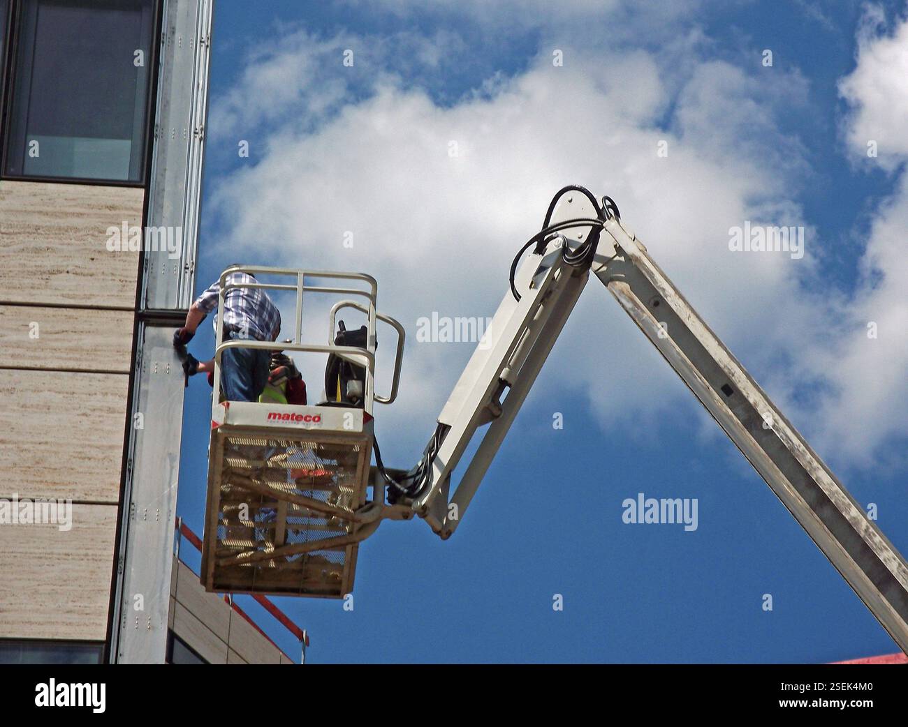 Construction worker in safety cage Stock Photo - Alamy