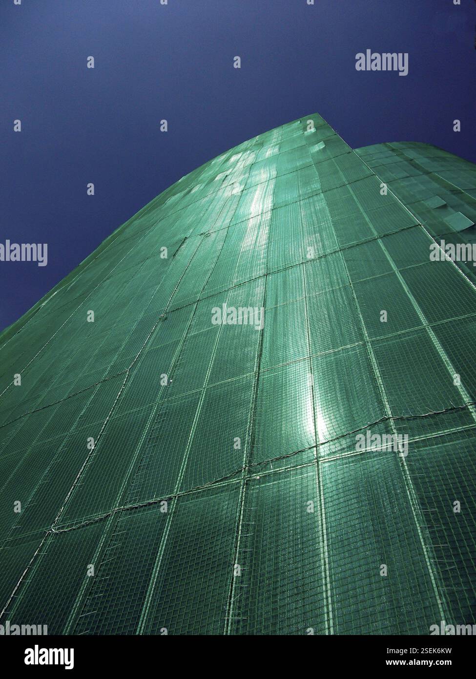 High-rise building, construction work, renovation, protective tarpaulin ...