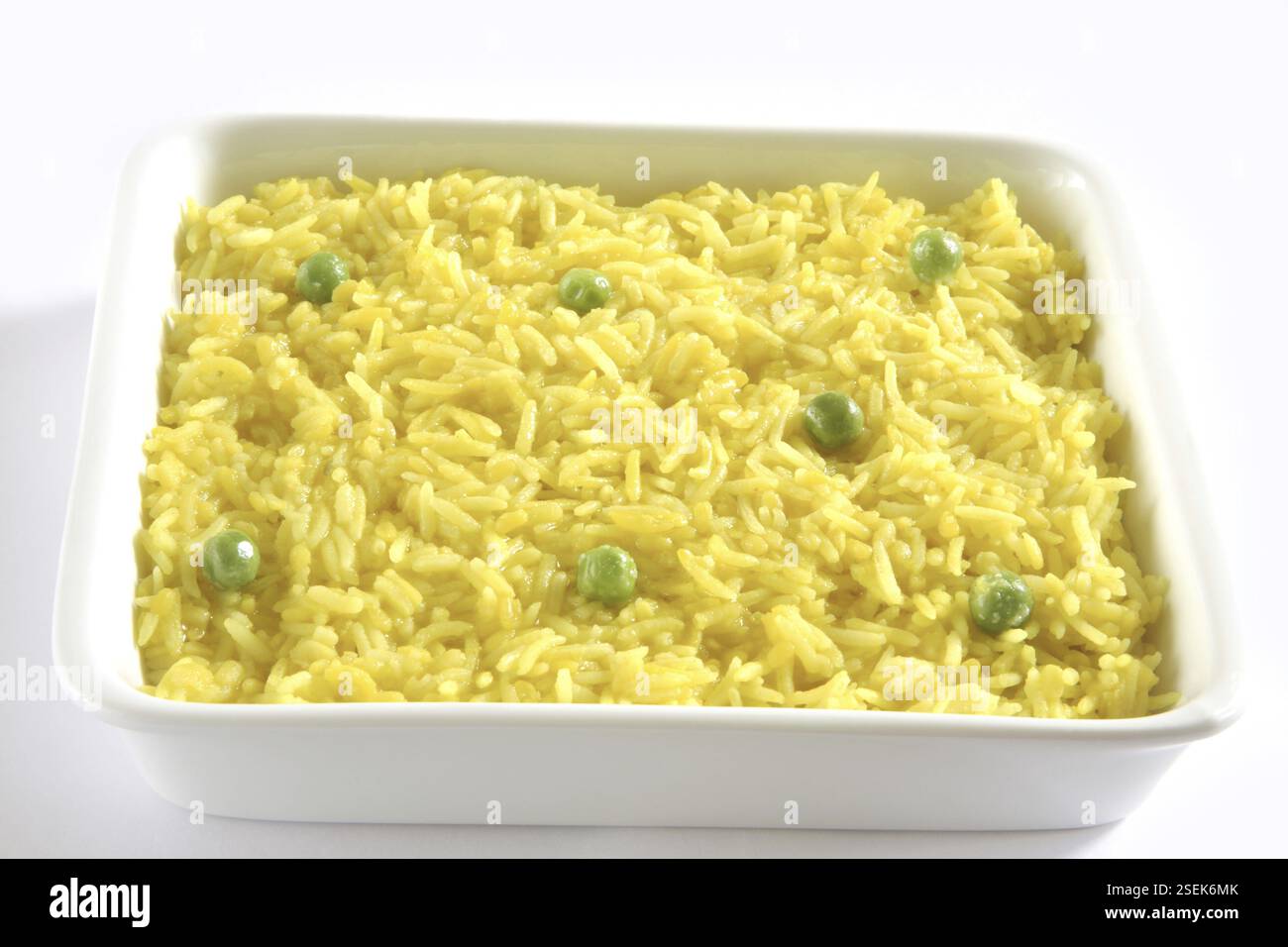 Indian cuisine khichdi garnish green peas served in deep plate on white ...