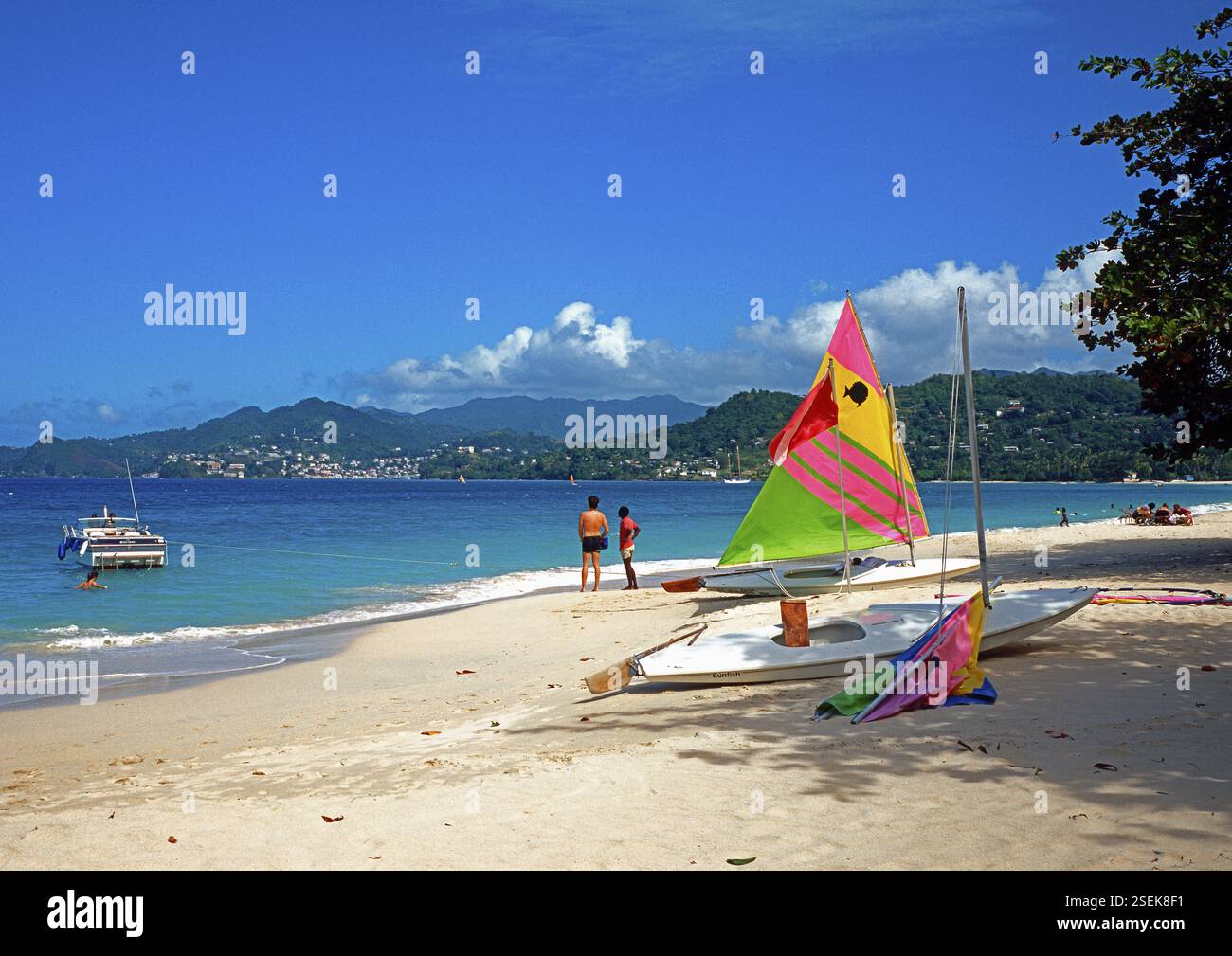 Grand Anse Beach, sailboat on the beach, motorboat anchoring ...