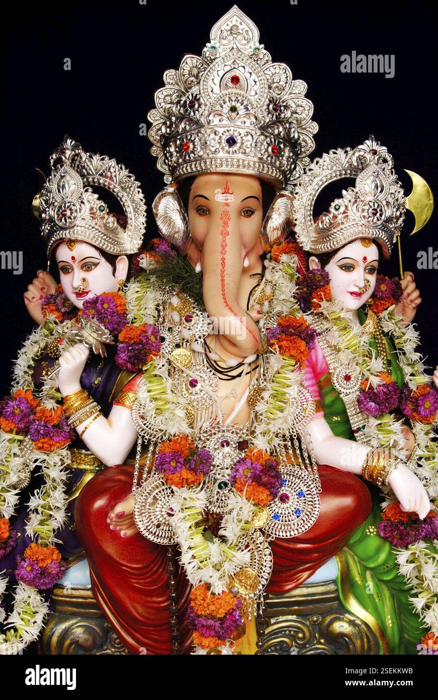 Richly decorated idol of lord ganesh elephant headed god sitting with ...