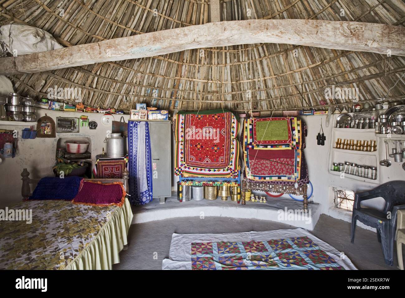 Interior of bhunga circular house with household utilities placed at ...
