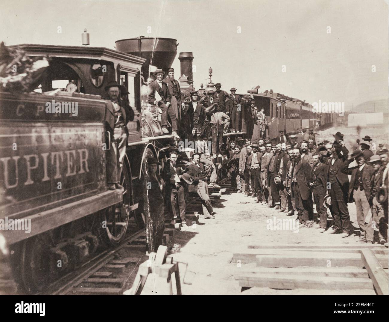 Crowd and workers in attendance at laying last rail of construction of ...