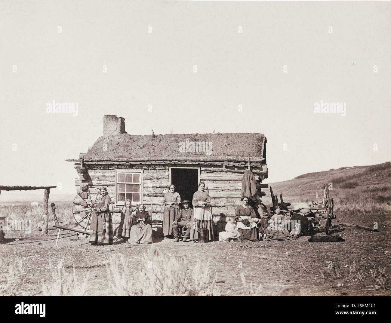 Mormon family, standing in front on old wooden house, Utah. Vintage ...