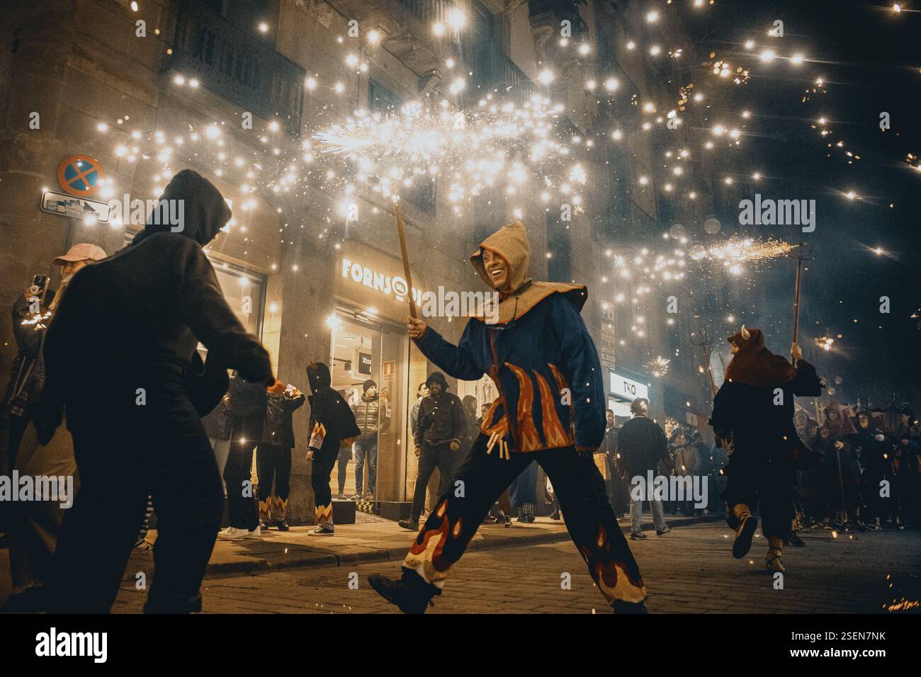 Barcelona, Spain. 8th Feb, 2025. A fire runner in a devil costume dance ...