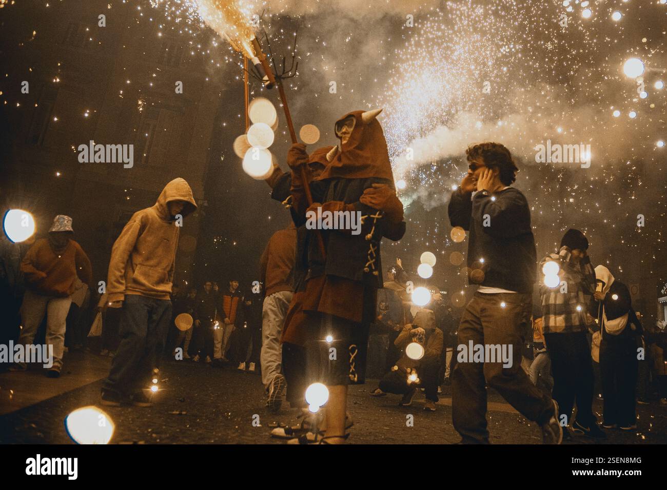 Barcelona, Spain. 8th Feb, 2025. A fire runner in a devil costume dance ...