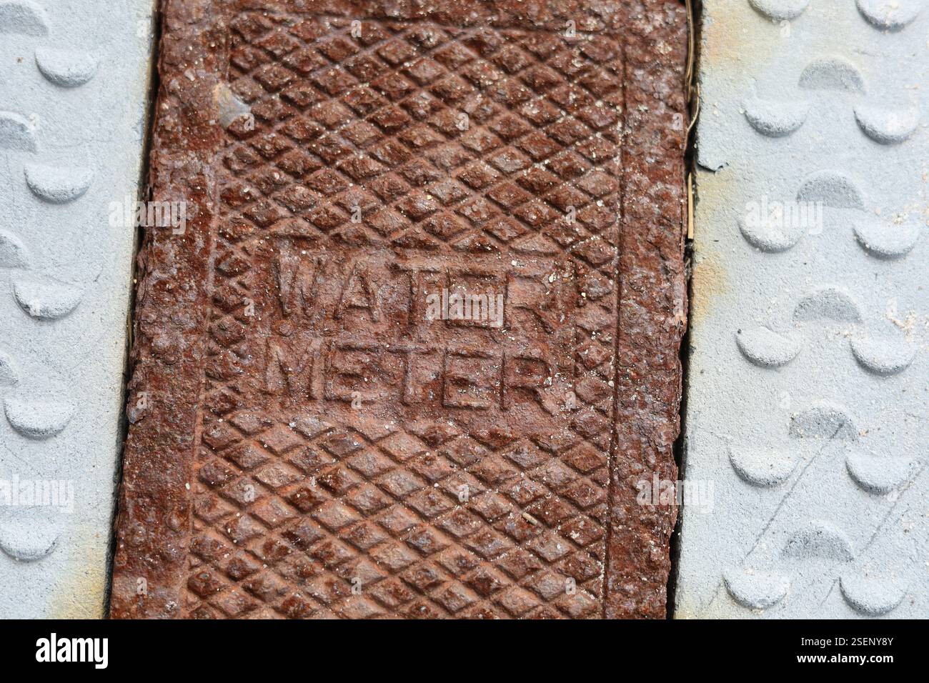 Water meter printed on rusty metal utility access panel Stock Photo - Alamy