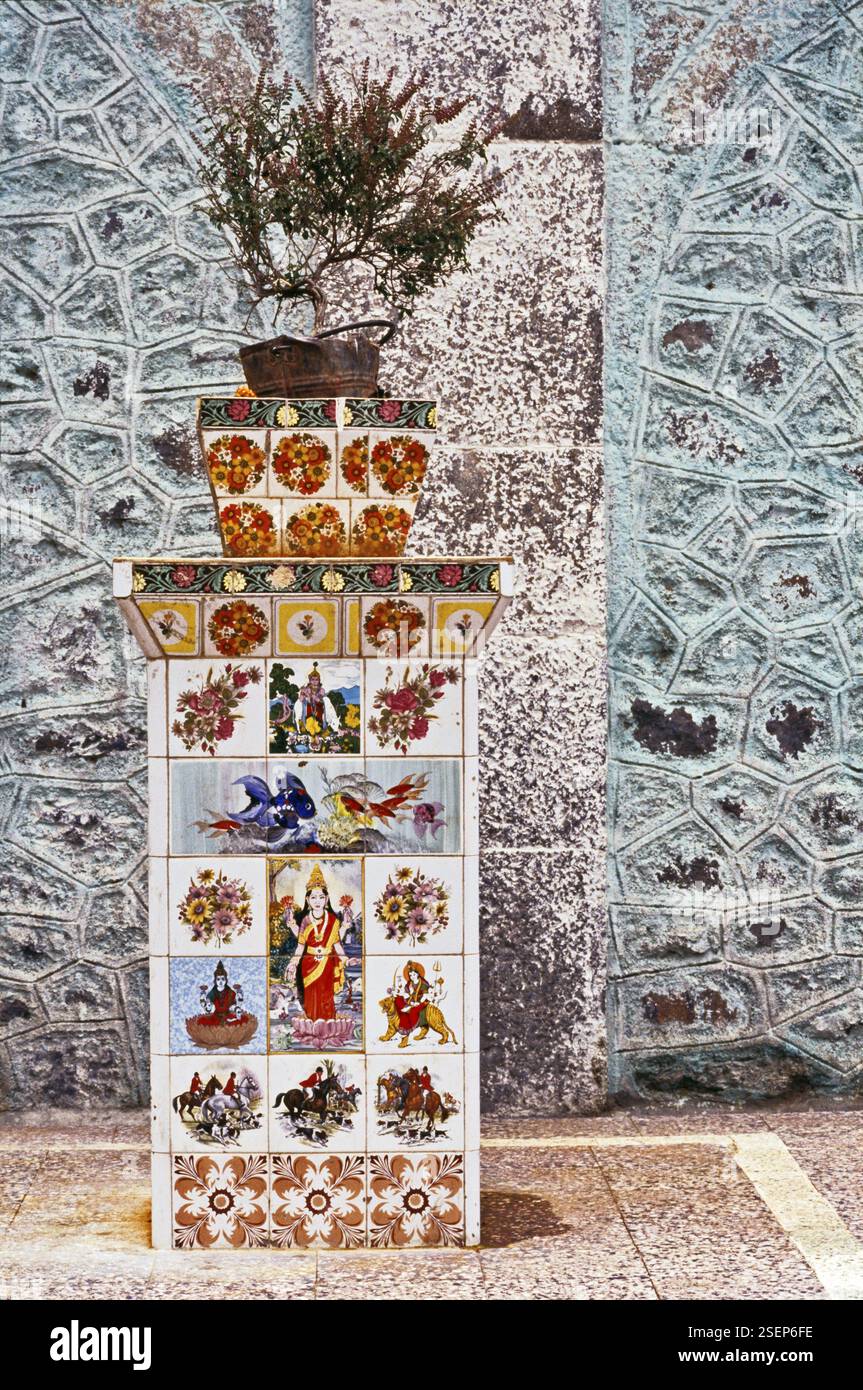 Tulsi plant on pedestal decorated with ceramic tiles printed with ...
