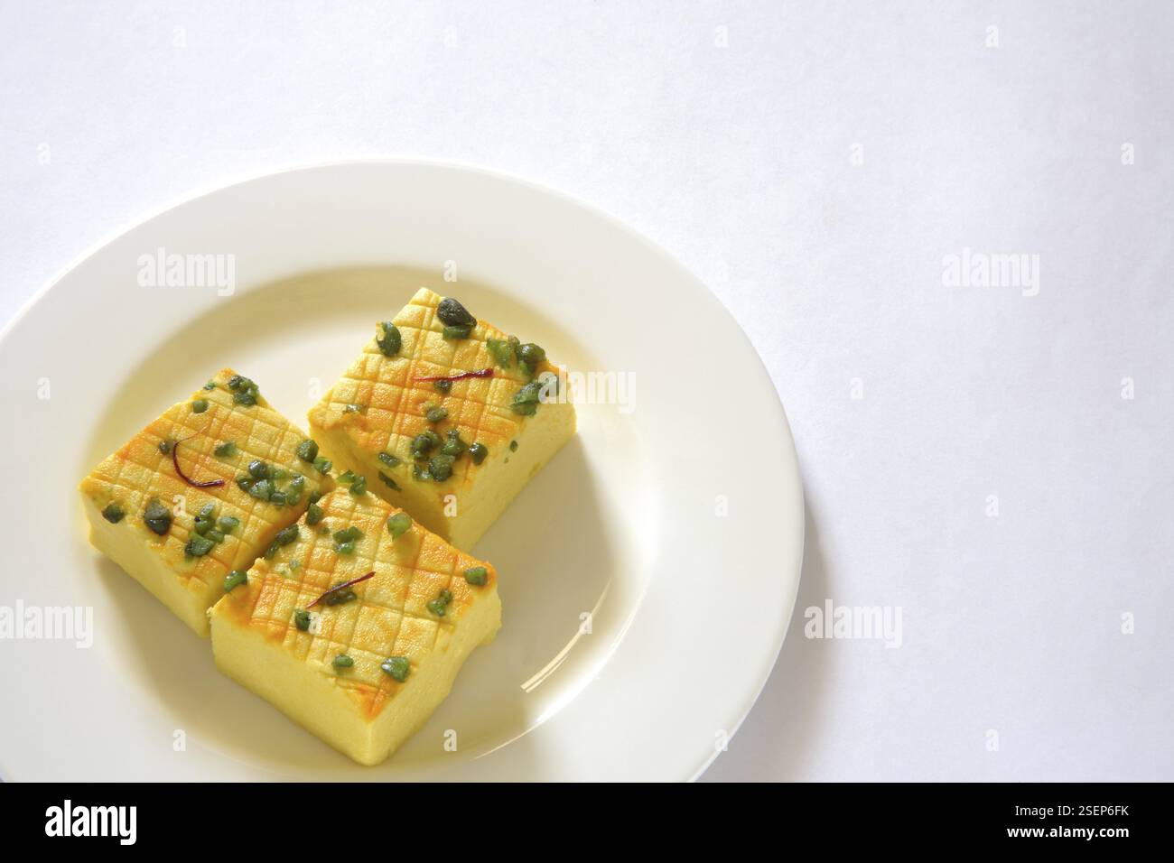 Indian sweet, sandesh bengali mithai garnish with pistachio and saffron ...