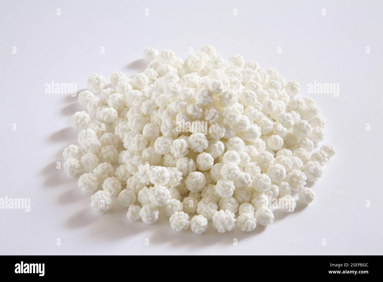 Sweet small sugar ball phutana on white background Stock Photo - Alamy