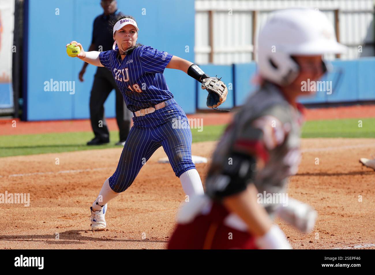 Houston Christian third baseman Haylie Savage (18) makes the throw to ...