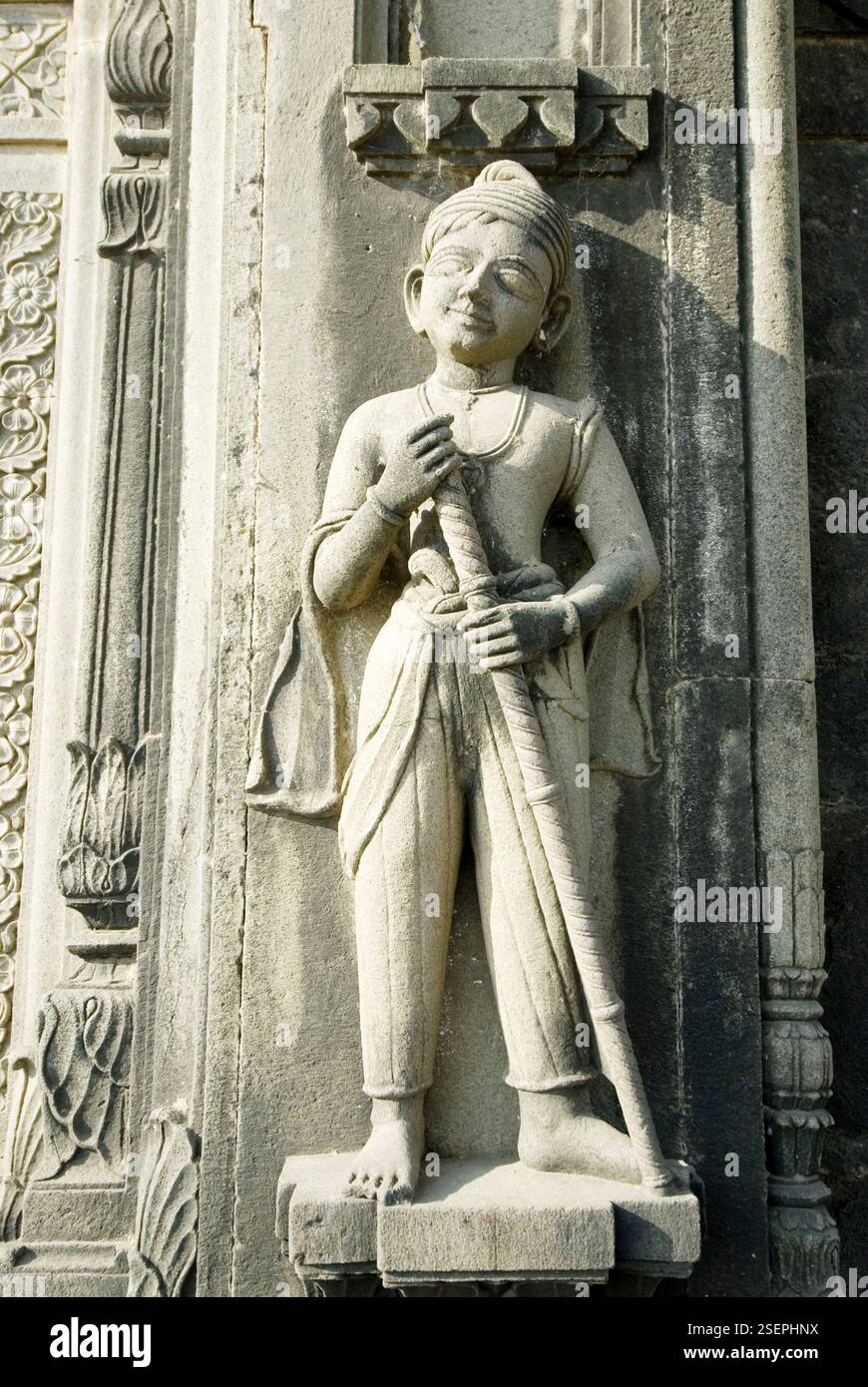Guard watchman carved in stone on gate of Maheshwar temple, Maheshwar ...