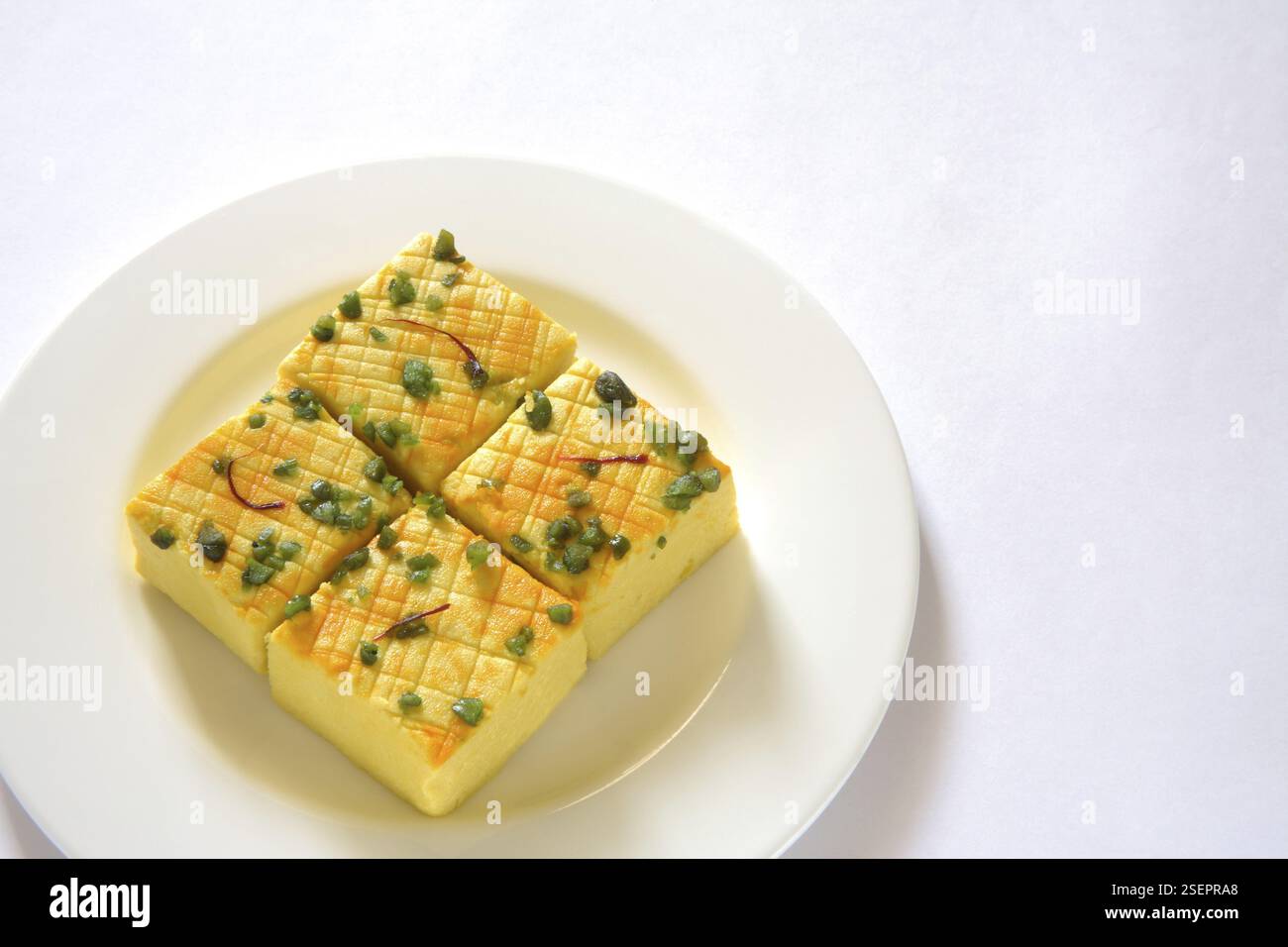 Indian sweet, sandesh bengali mithai garnish with pistachio and saffron ...