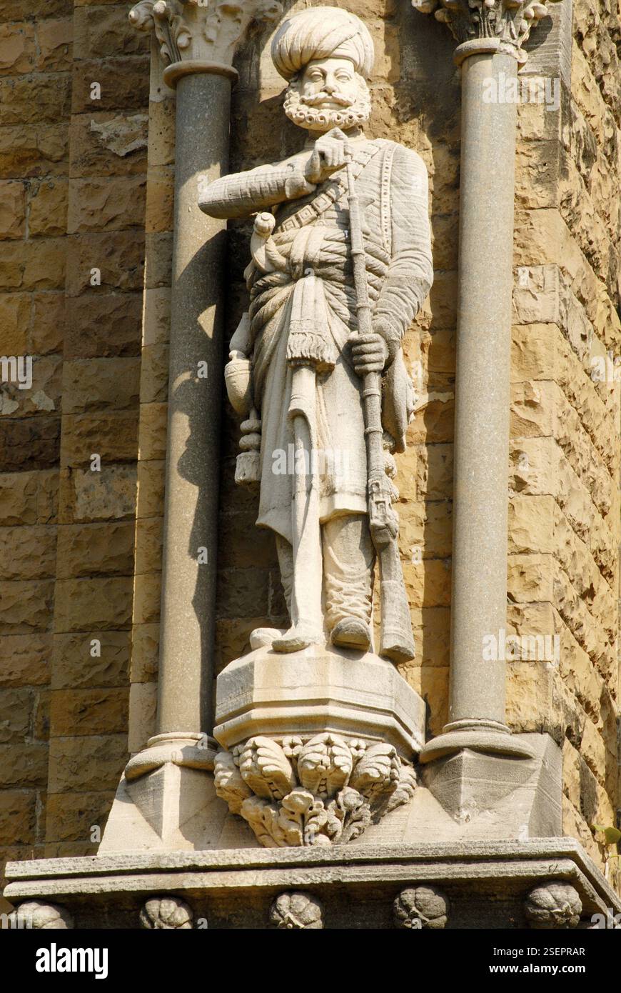 Richly carved human figure local man on Rajabai tower clock tower ...