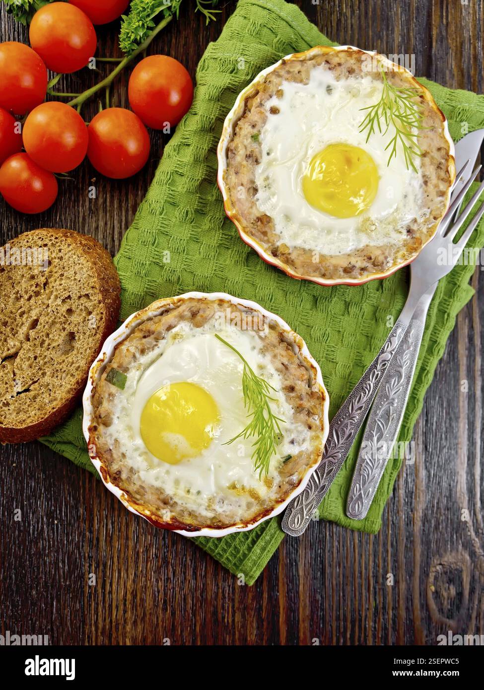 Two forms of tartlets with meat and eggs in the forms on a napkin ...
