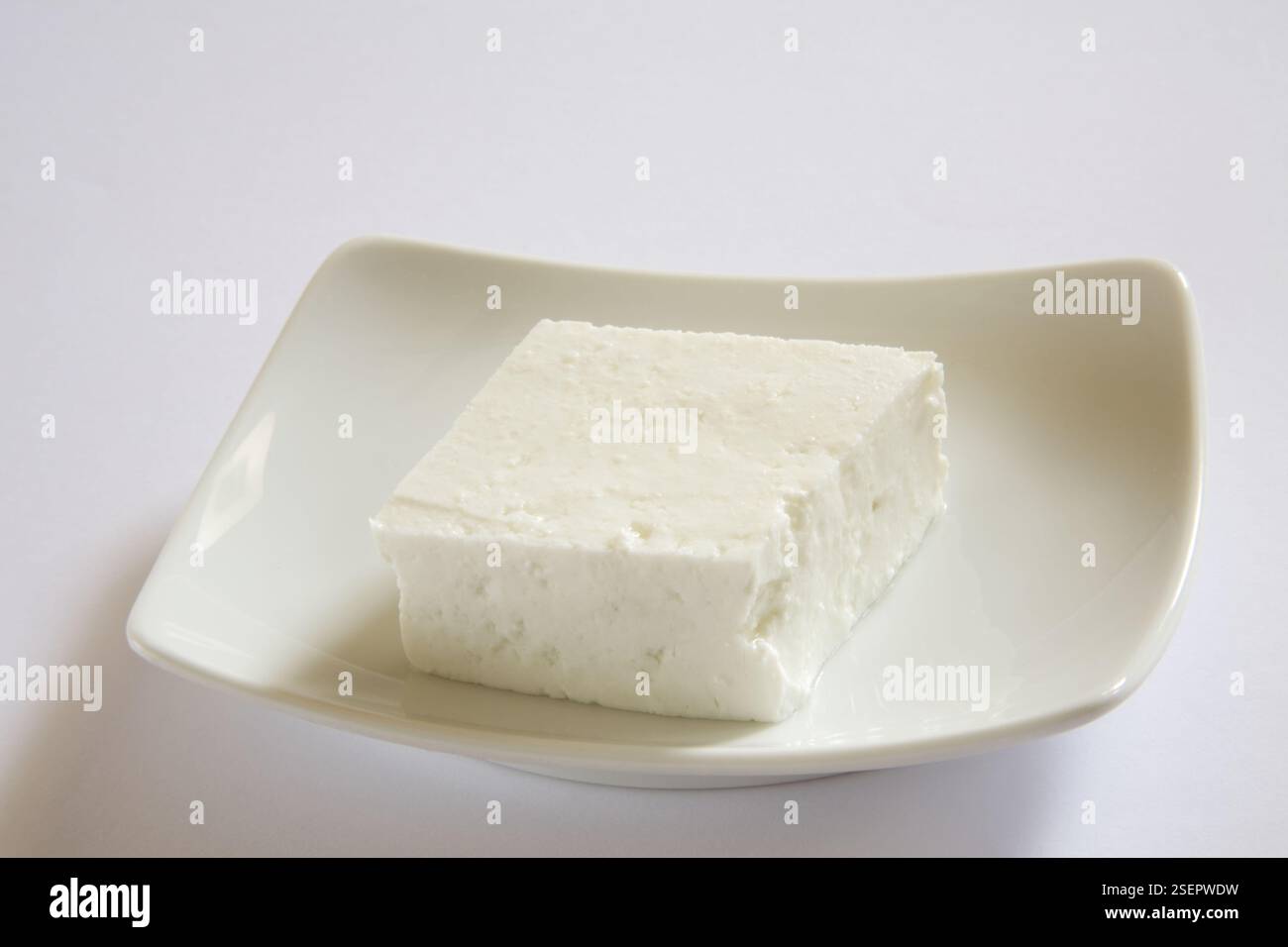 Cottage paneer pressed into firm or soft mass home or dairy product ...