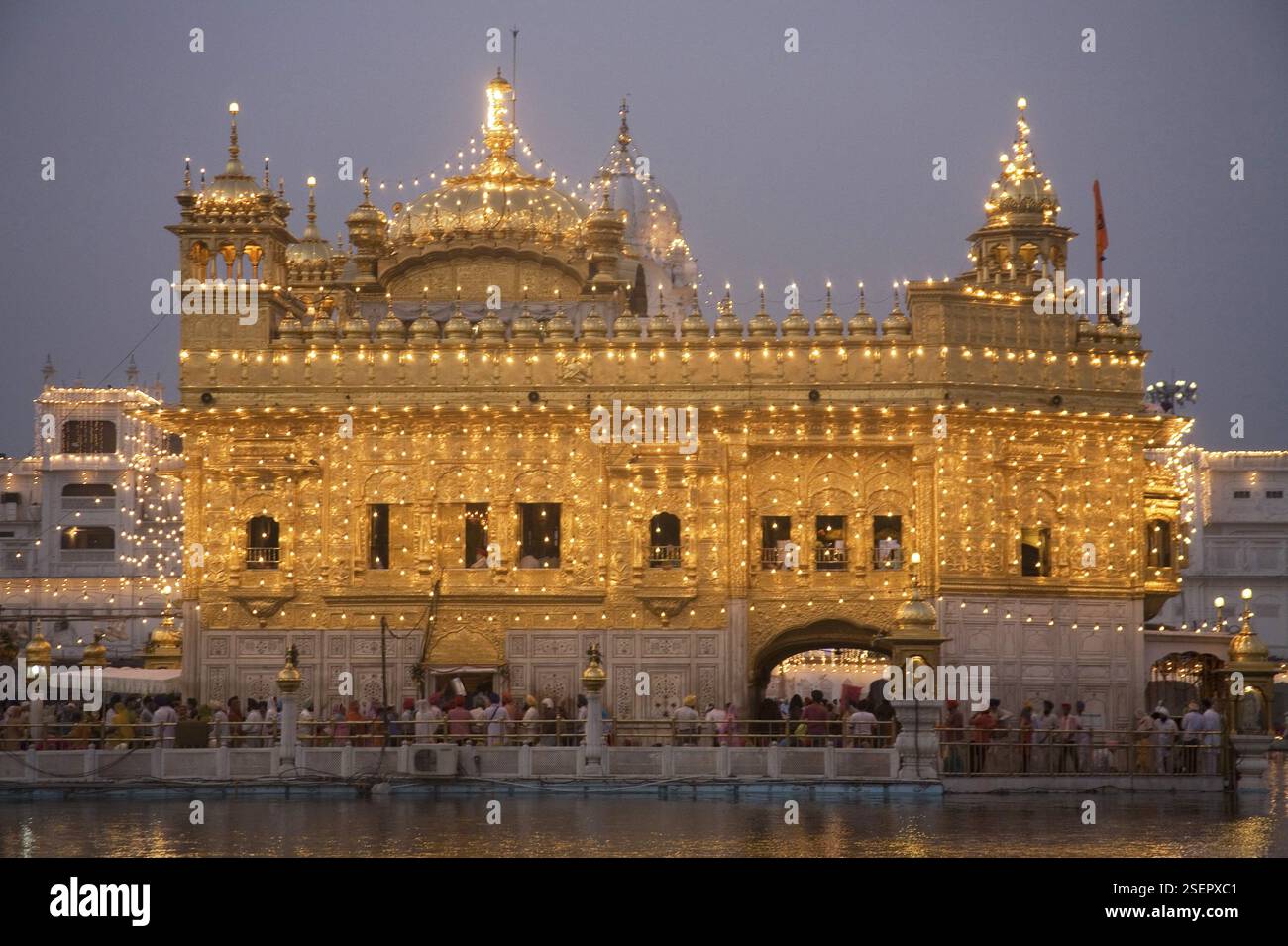 Illuminated Hari Mandir Sahib swarn mandir or golden temple during ...
