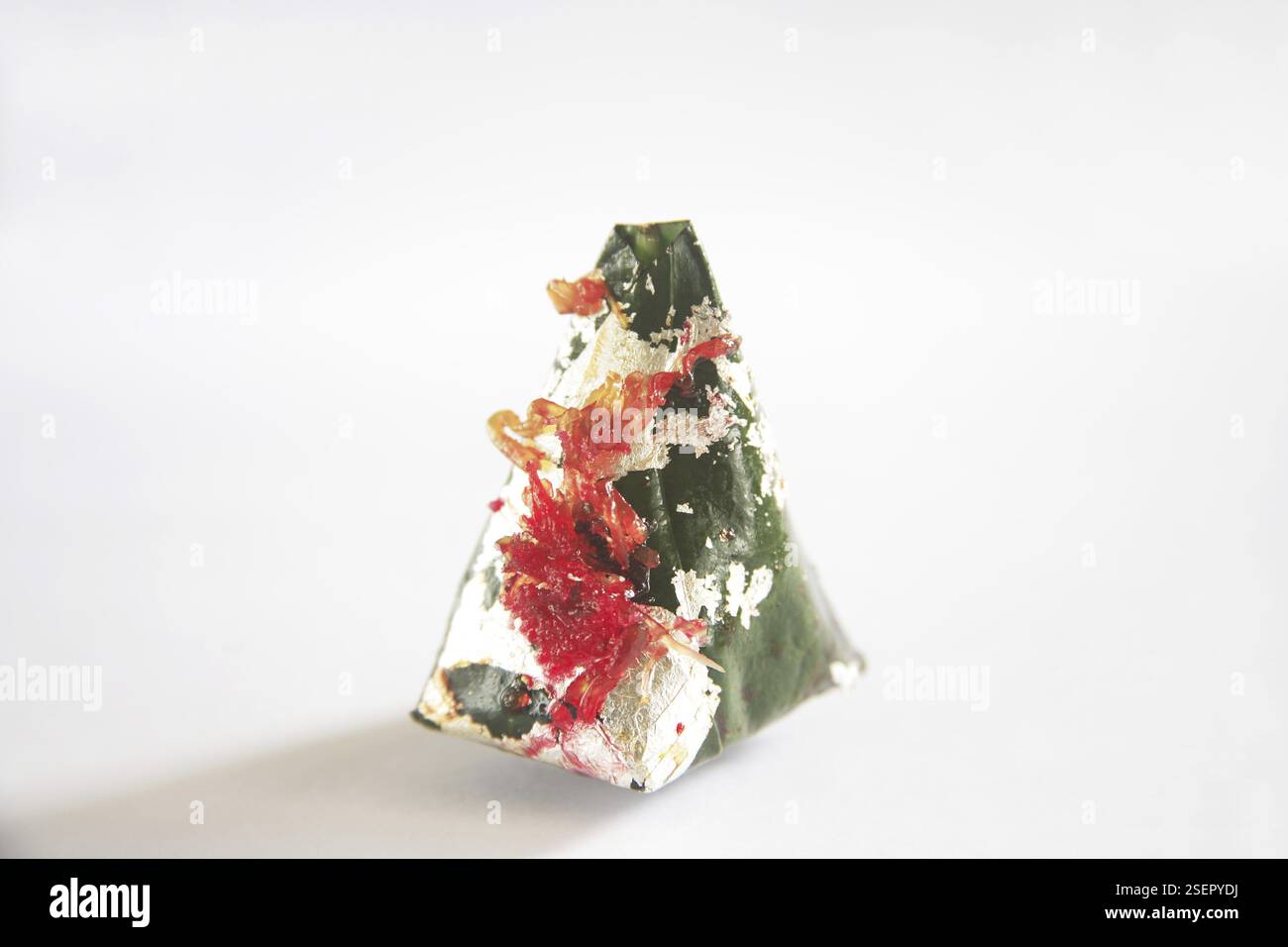 Gilouri pan prepared and folded in betel leaves on white background ...