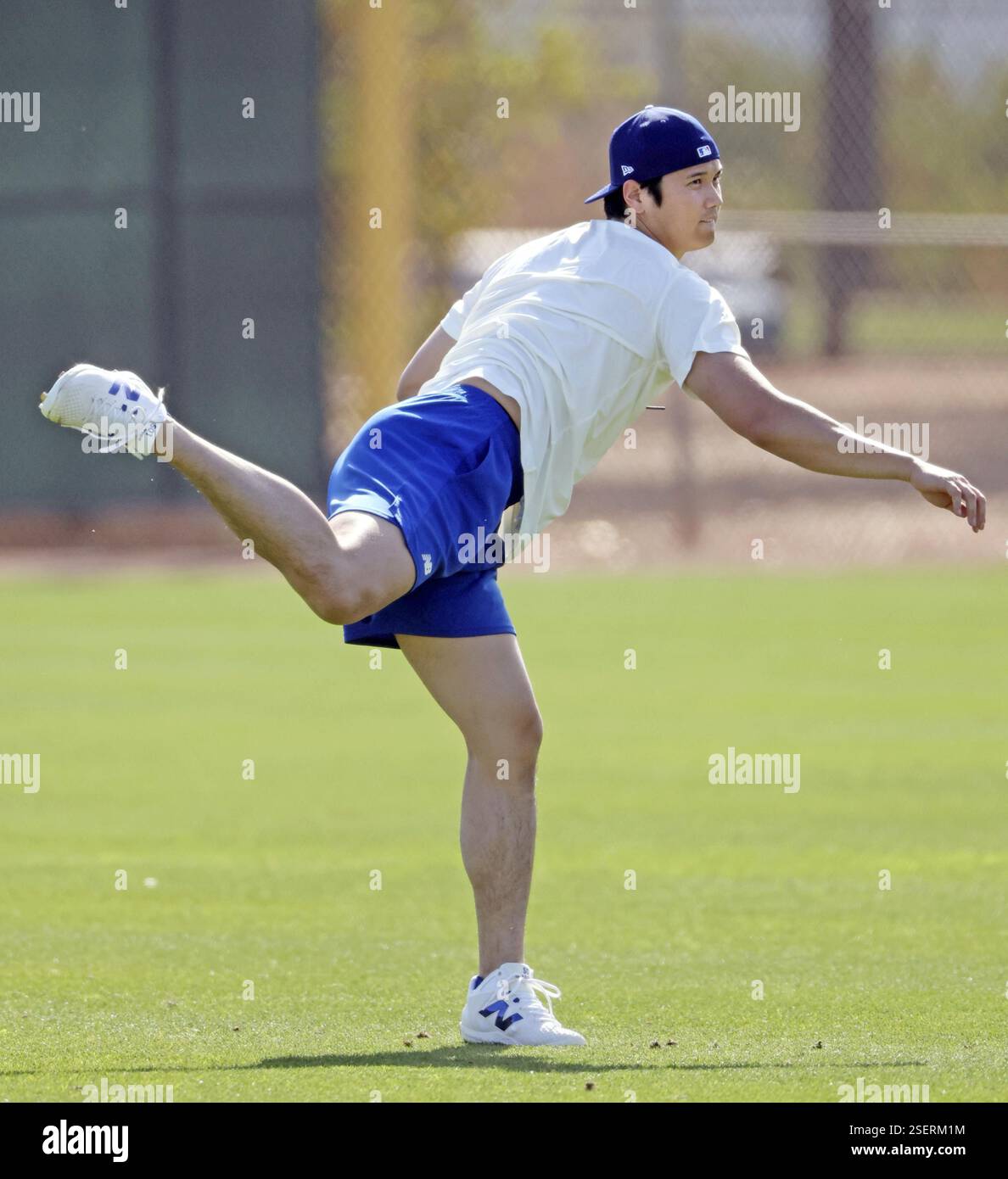 Shohei Ohtani of the Los Angeles Dodgers plays catch during a workout ...