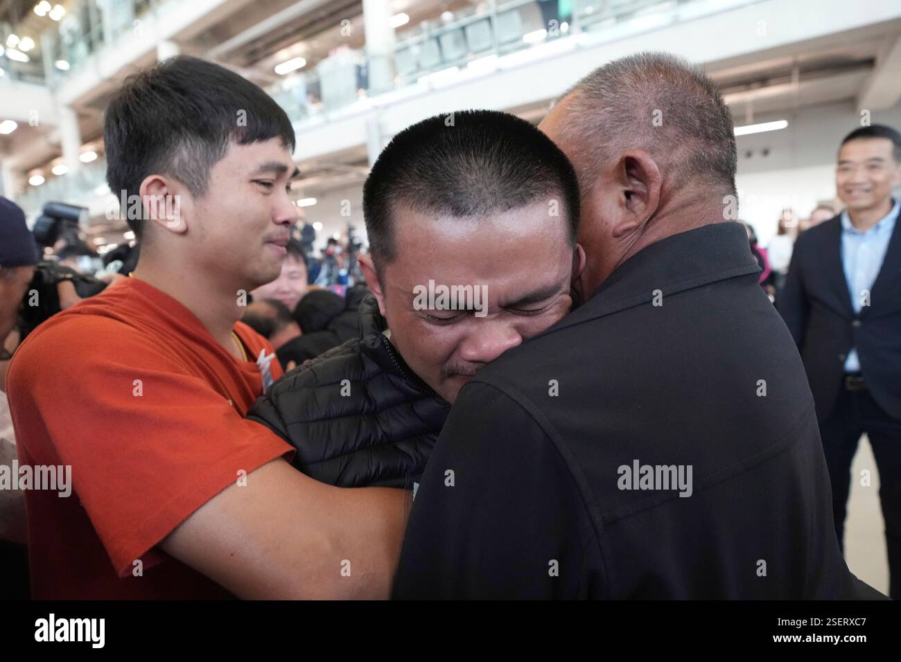 A Thai hostage who was freed from Hamas, Pongsak Thaenna, center, hugs ...