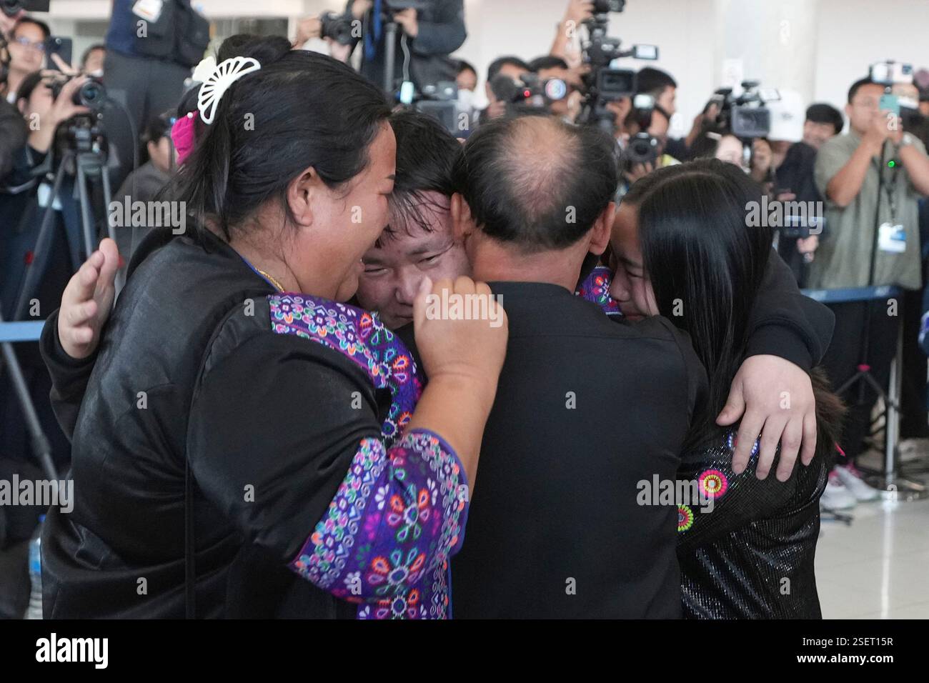A Thai hostage who was freed from Hamas, Bannawat Saethao, second from left hugs relatives upon ...