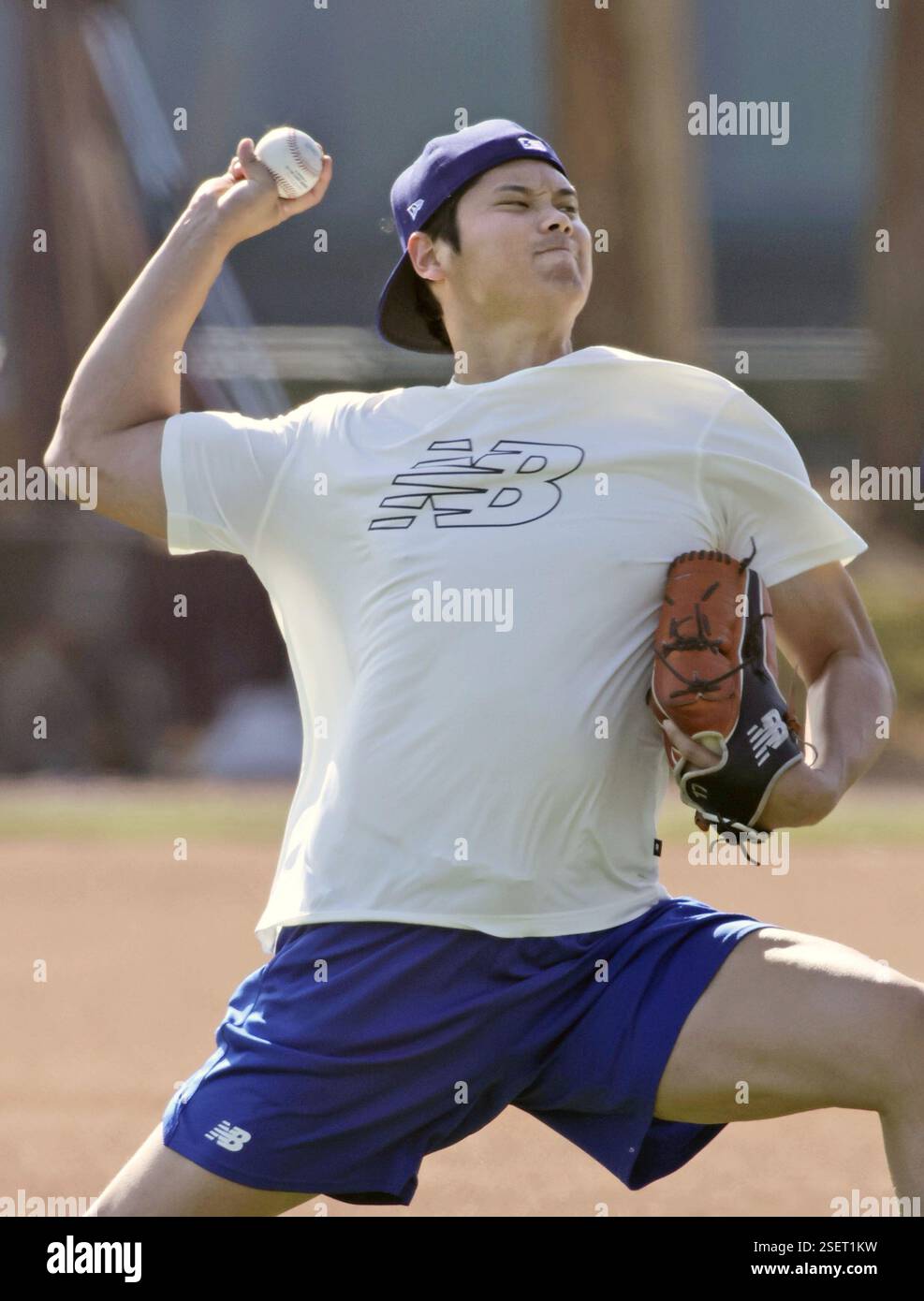 Shohei Ohtani of the Los Angeles Dodgers plays catch during a workout ...