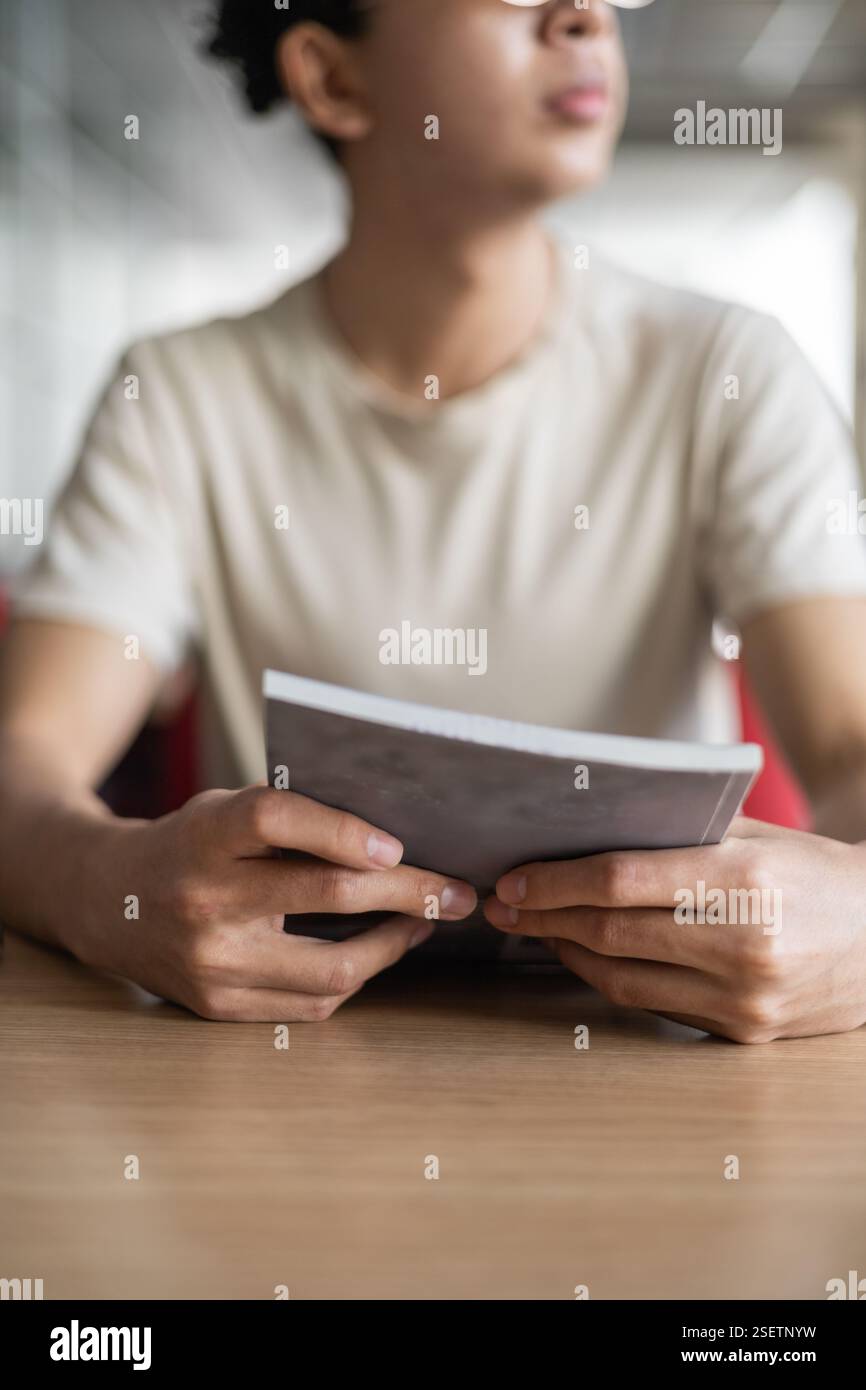 A young boy holding his notebook, ready to study or take notes. Perfect ...