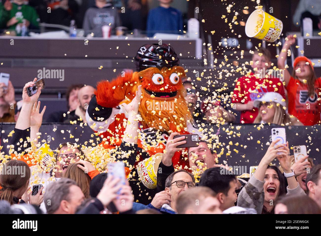 Philadelphia Flyers mascot Gritty makes a mess with some popcorn during ...