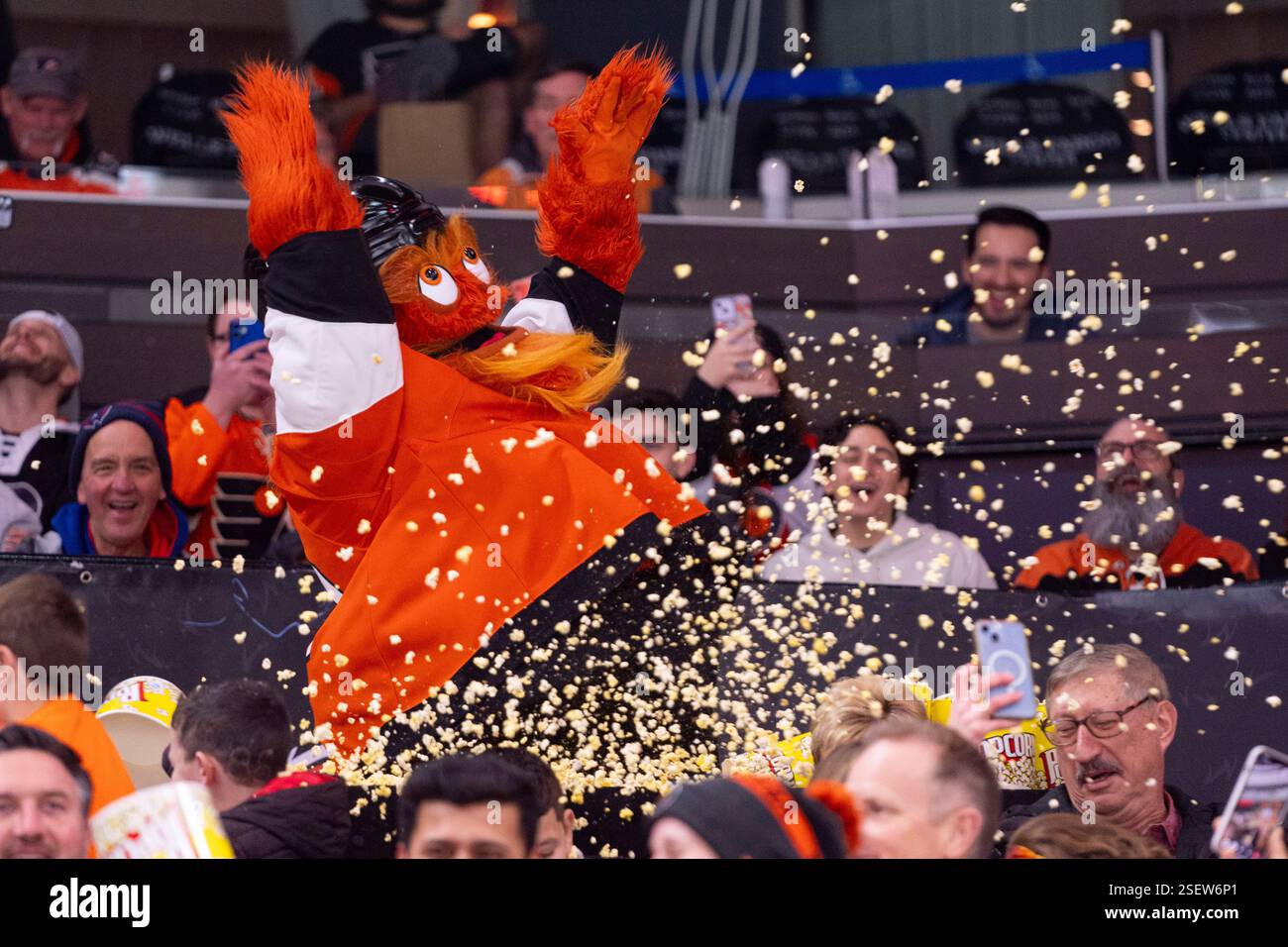 Philadelphia Flyers mascot Gritty makes a mess with some popcorn during ...