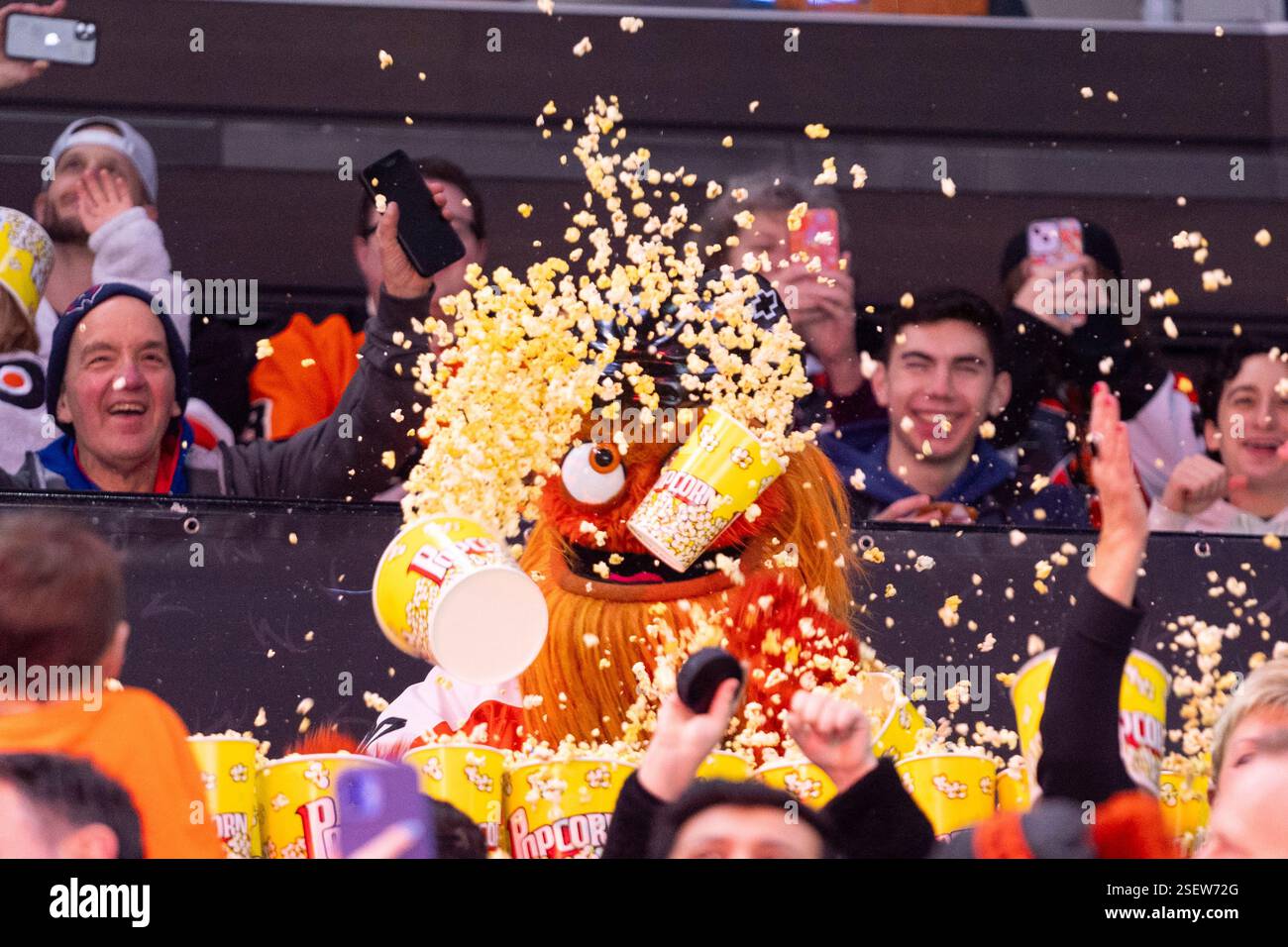 Philadelphia Flyers mascot Gritty makes a mess with some popcorn during ...