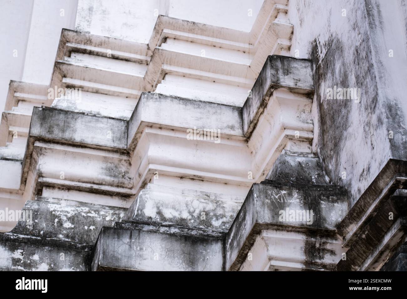 The corner detail of a religious building, pagoda, with layers of white ...