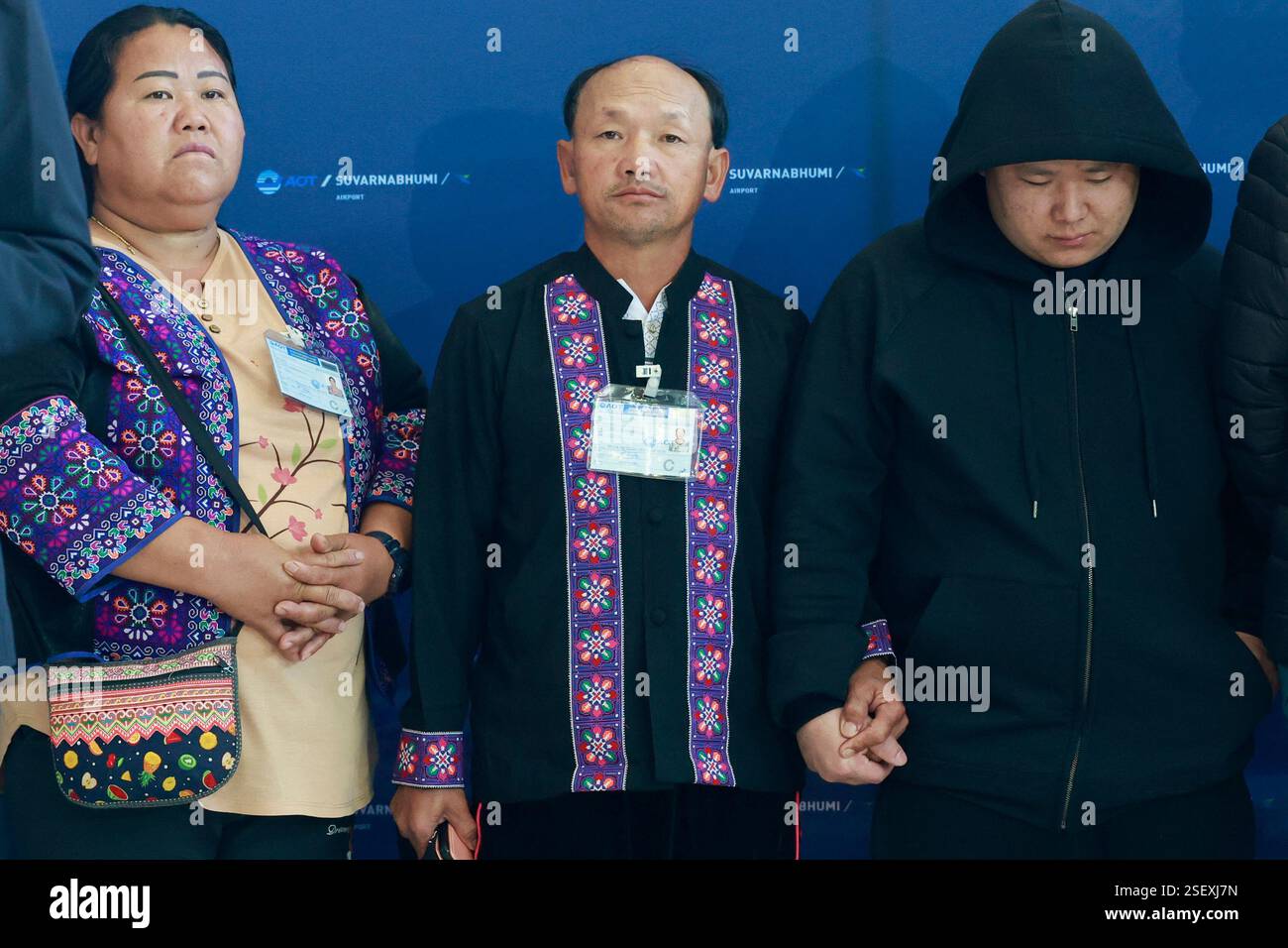 A Thai hostage who was freed from Hamas, Bannawat Saethao, right holds the hand of a relative ...