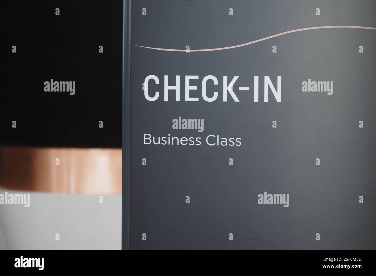 Check-in sign for business class at an airport terminal Stock Photo - Alamy