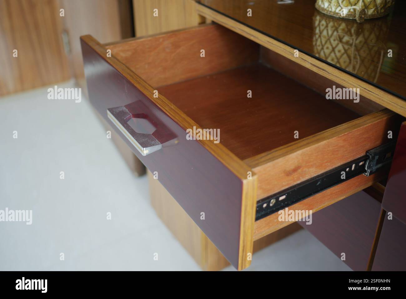 Open drawer in wooden cabinet revealing its interior space Stock Photo ...