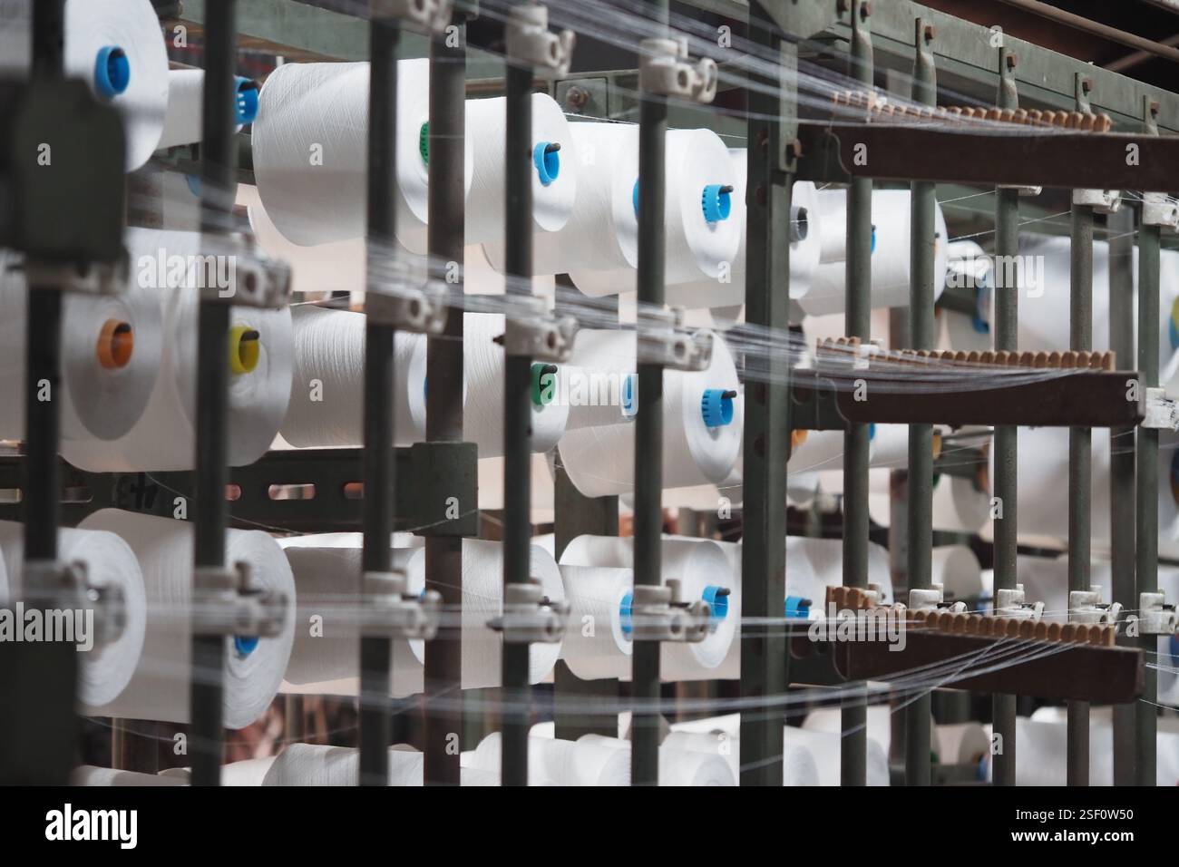 Textile manufacturing process in action at a factory facility Stock ...