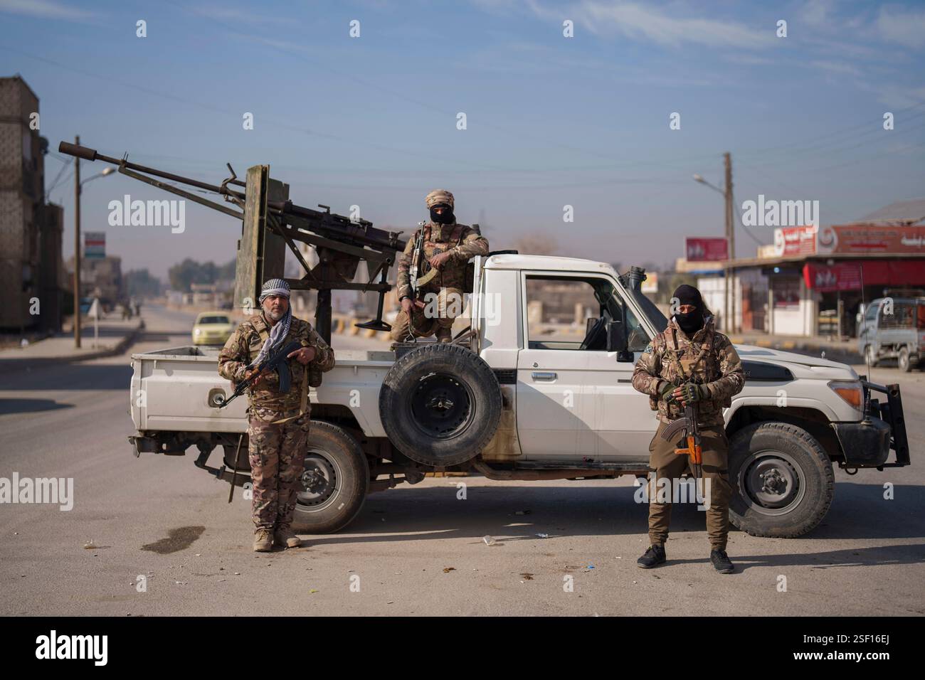 Members of the Syrian Democratic Forces pose for a portrait at a ...
