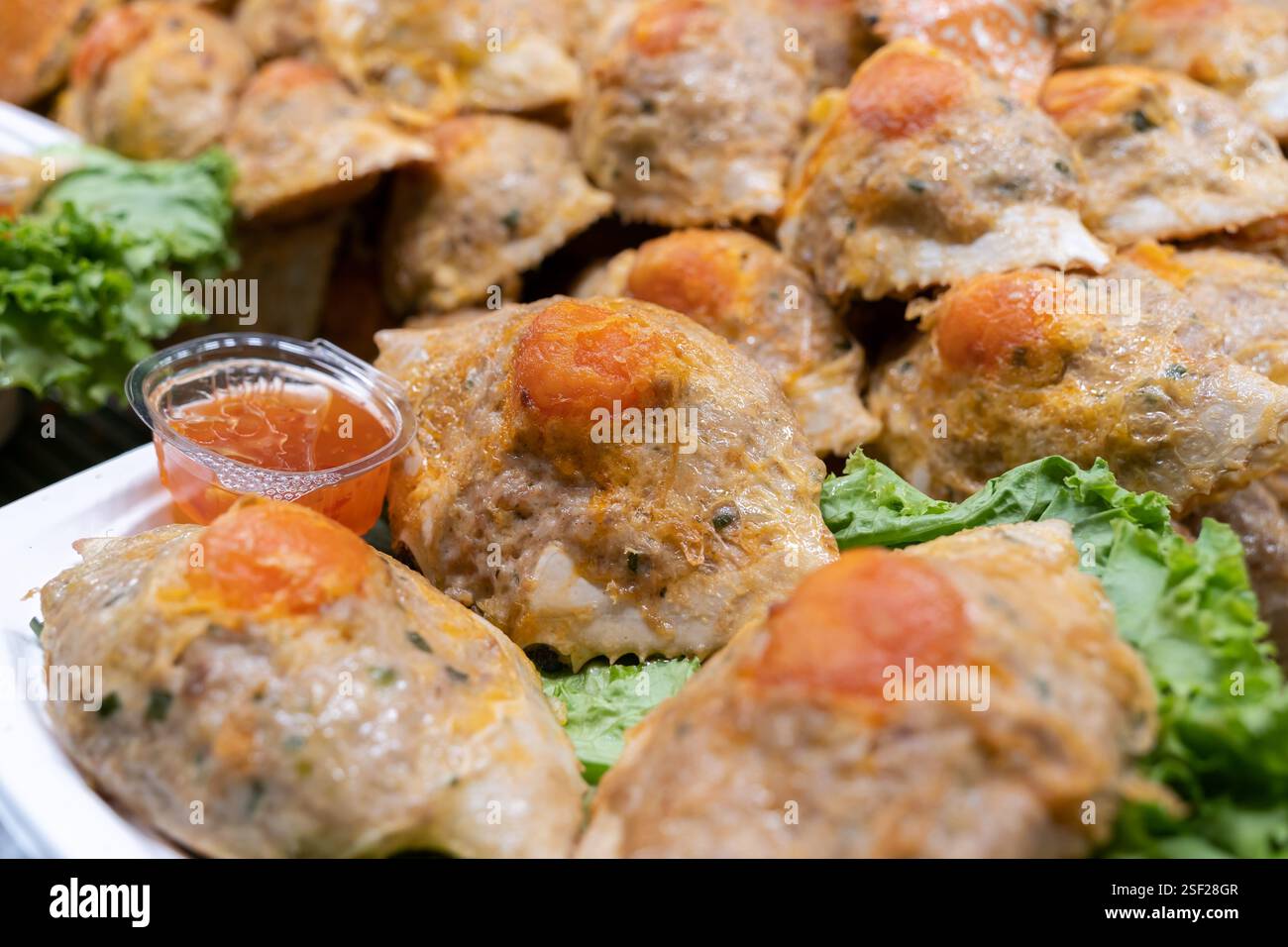 A mix of crab and chicken served inside crab shells with chilli sauce ...