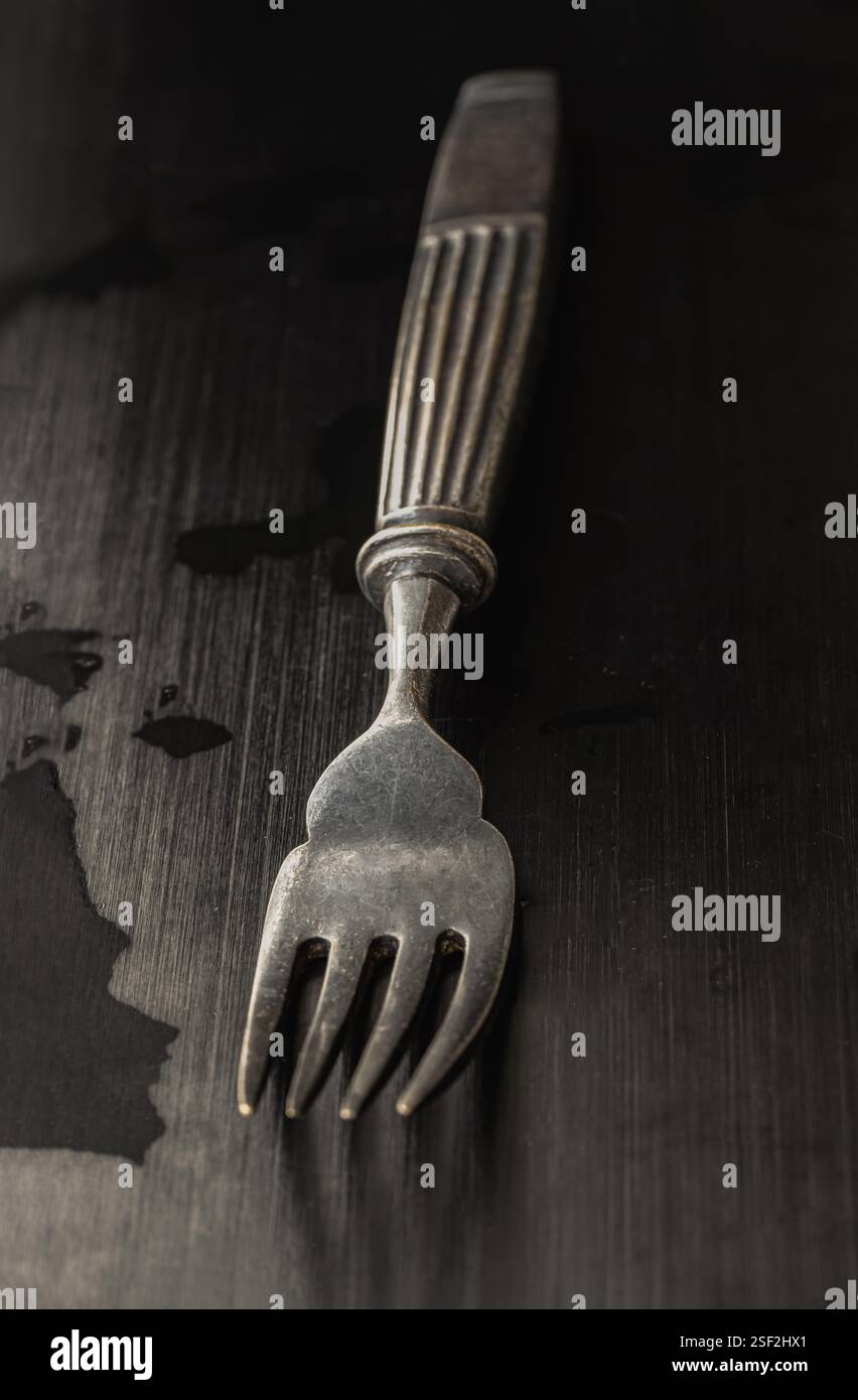 View of Black worn metal vintage fork in dark tone. Ancient vintage ...