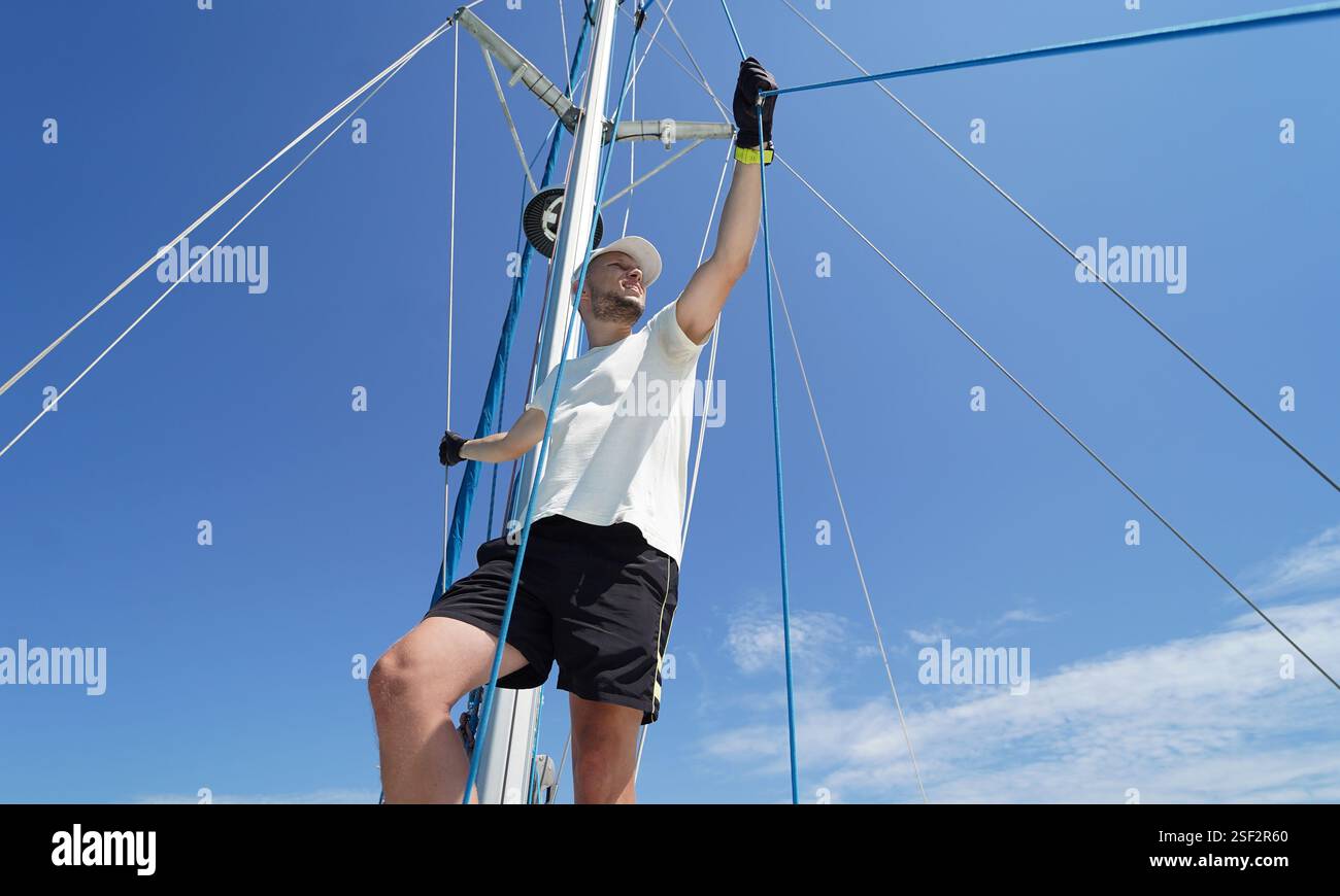 Male captain stands proudly on a sailboat enjoying the moment Stock ...