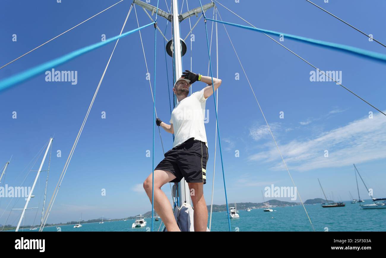 Male captain stands proudly on a sailboat enjoying the moment Stock ...