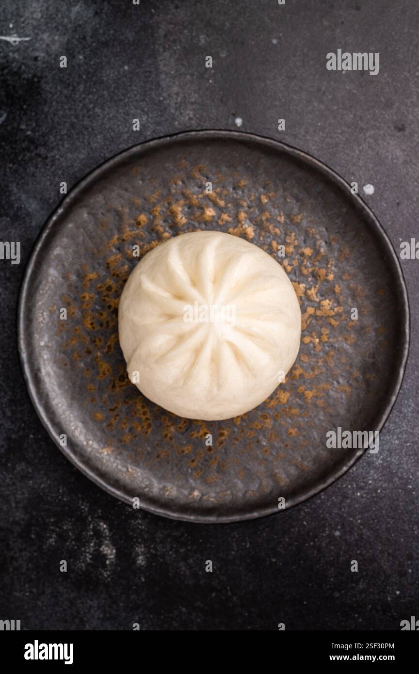 Chinese Steam Bao bun with meat on plate with chopsticks. black ...
