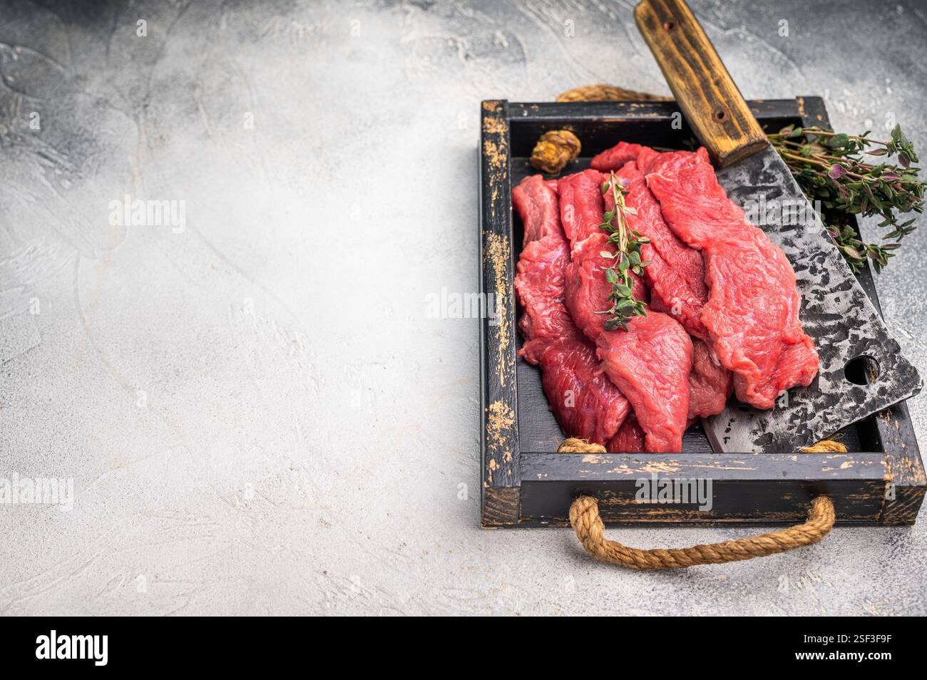 Raw horse meat slices in a wooden tray, showcasing its appealing color ...